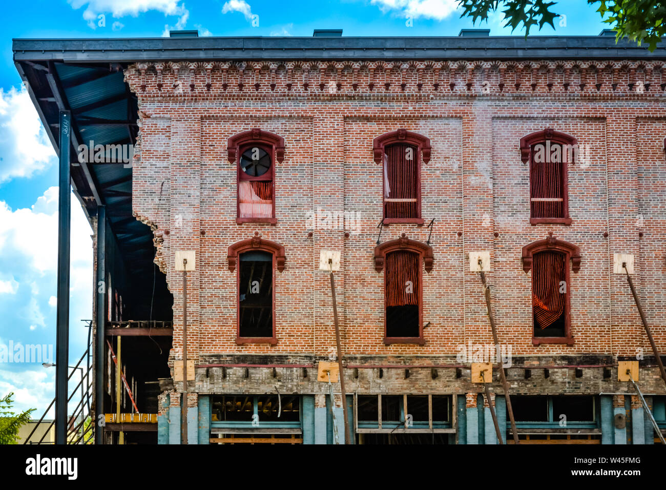 A partially demolished vintage brick building, making way for urban ...