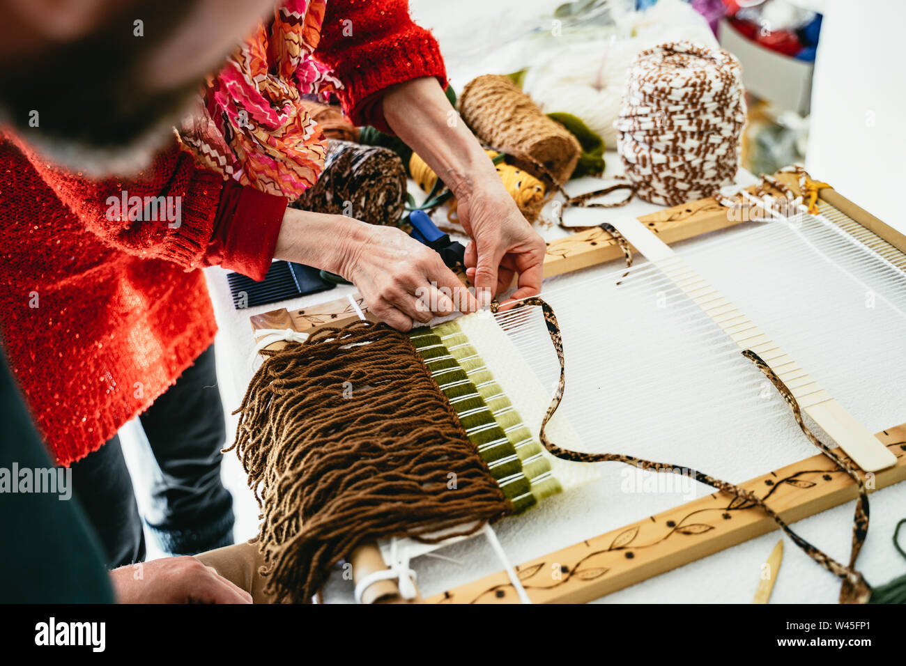 Teacher demonstrating making a fringe Stock Photo - Alamy