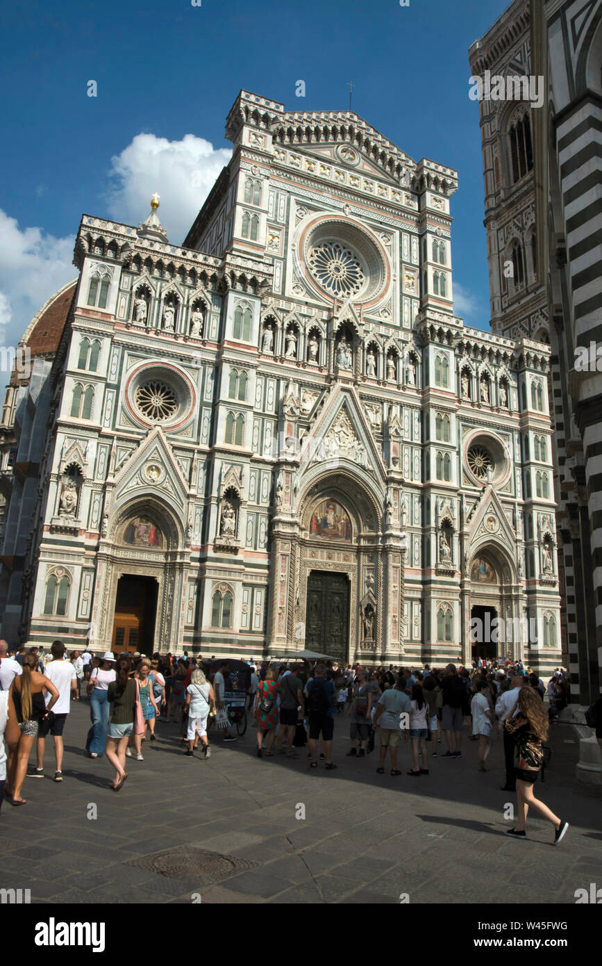 FLORENCE, ITALY, July 2018, Tourist at facade of the Florence Cathedral ...