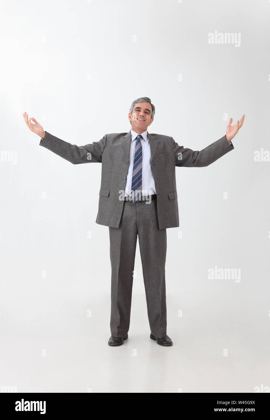 Businessman standing with his arms outstretched Stock Photo - Alamy