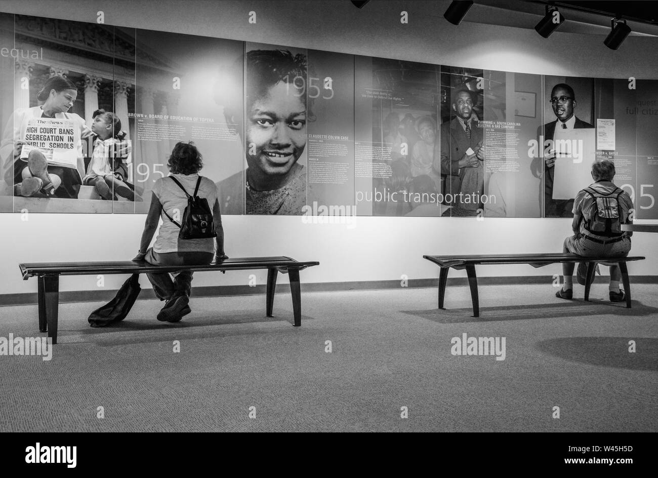 Several visitors sit on a bench to read the storytelling of the civil ...
