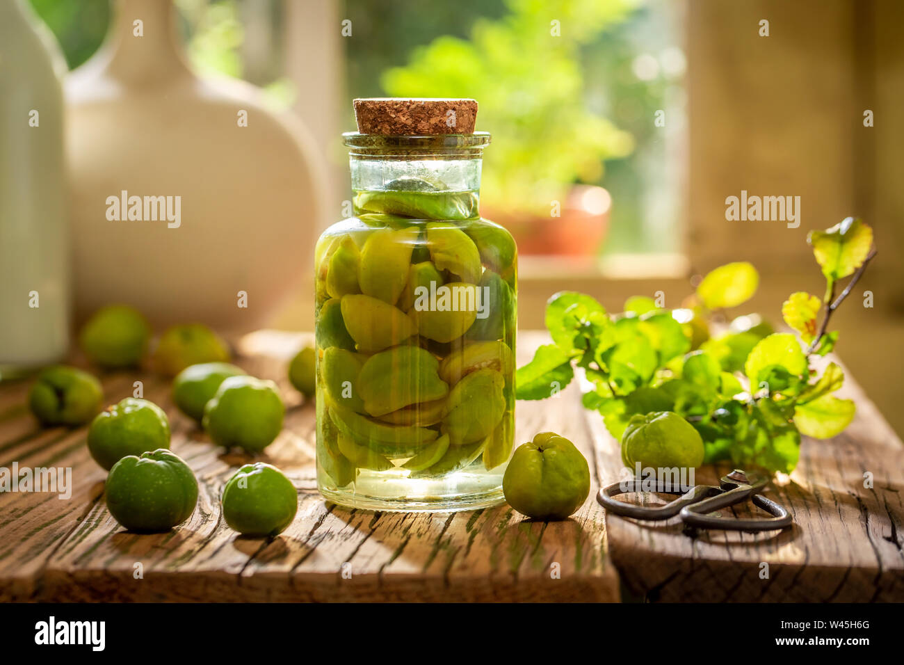 Homemade quince tincture made of fresh fruits and alcohol Stock Photo ...