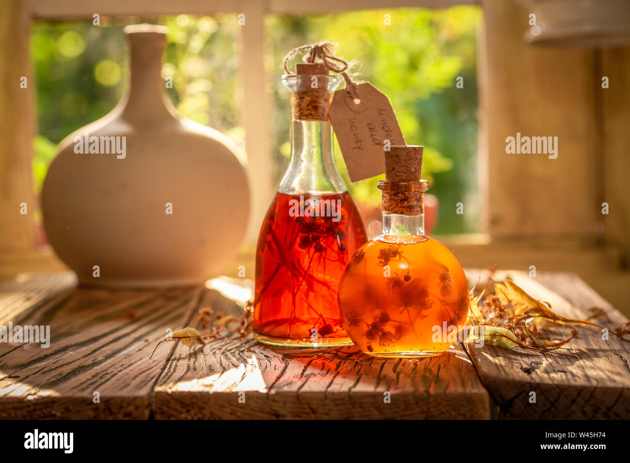 Homemade tincture made of alcohol, honey and linden Stock Photo - Alamy