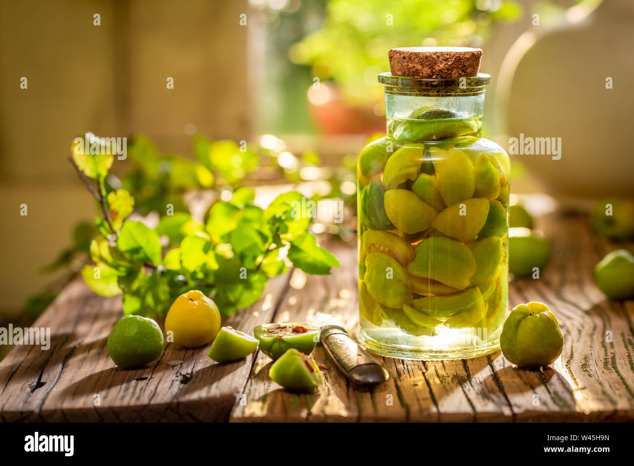 Sweet quince tincture made of fresh fruits and alcohol Stock Photo - Alamy
