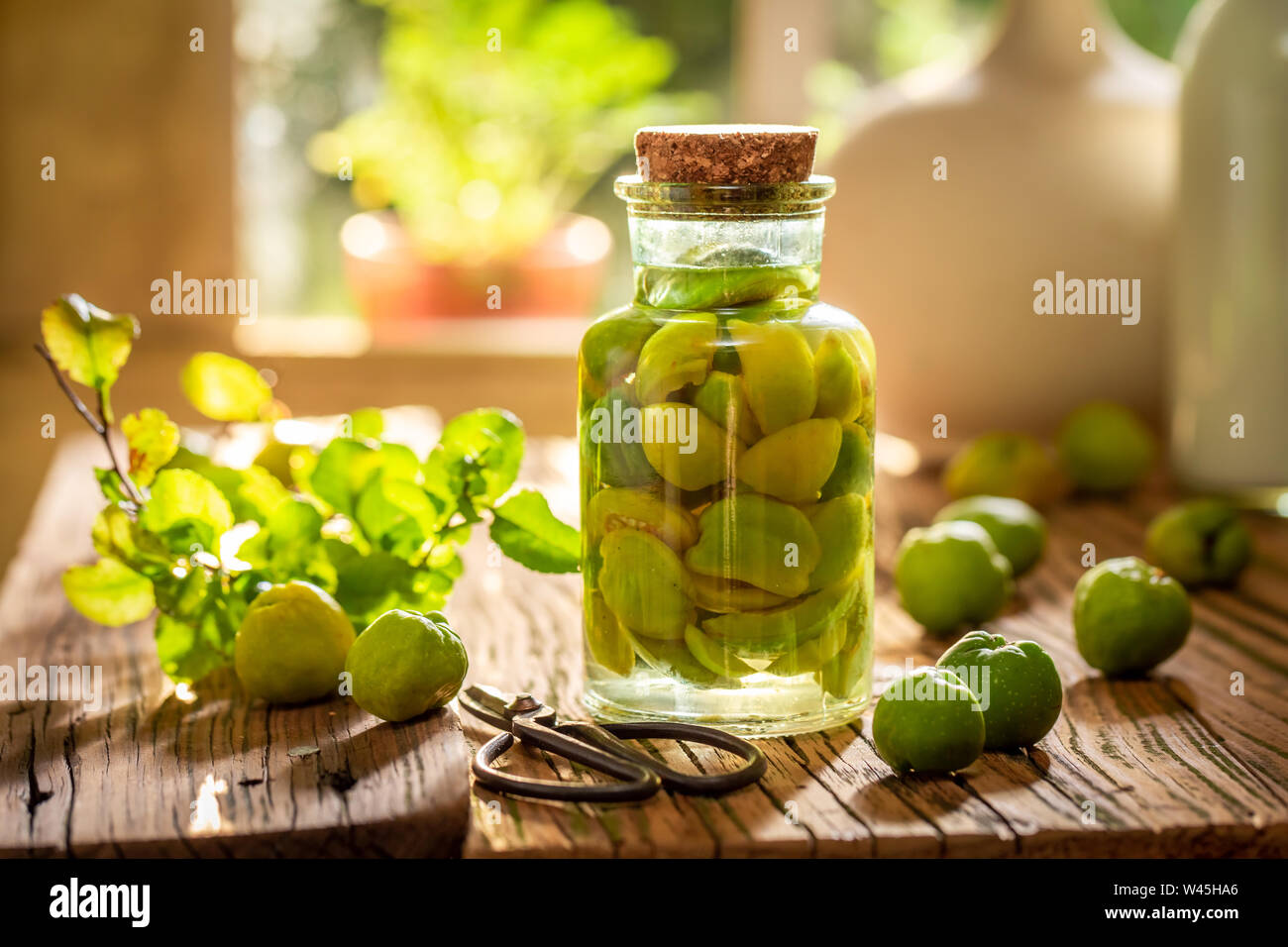Strong quince tincture made of fresh fruits and alcohol Stock Photo - Alamy