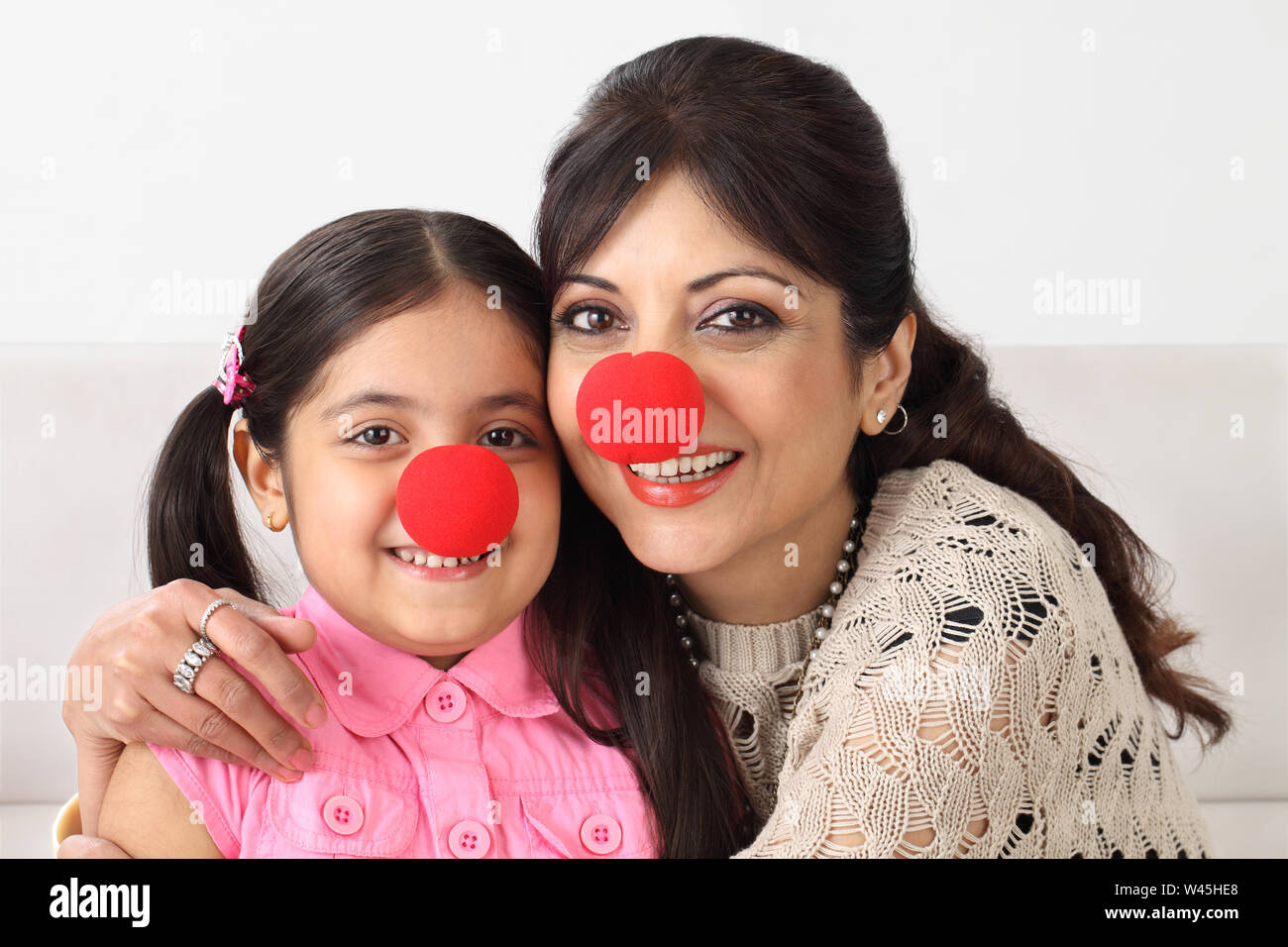 Mother and daughter wearing clown nose Stock Photo - Alamy