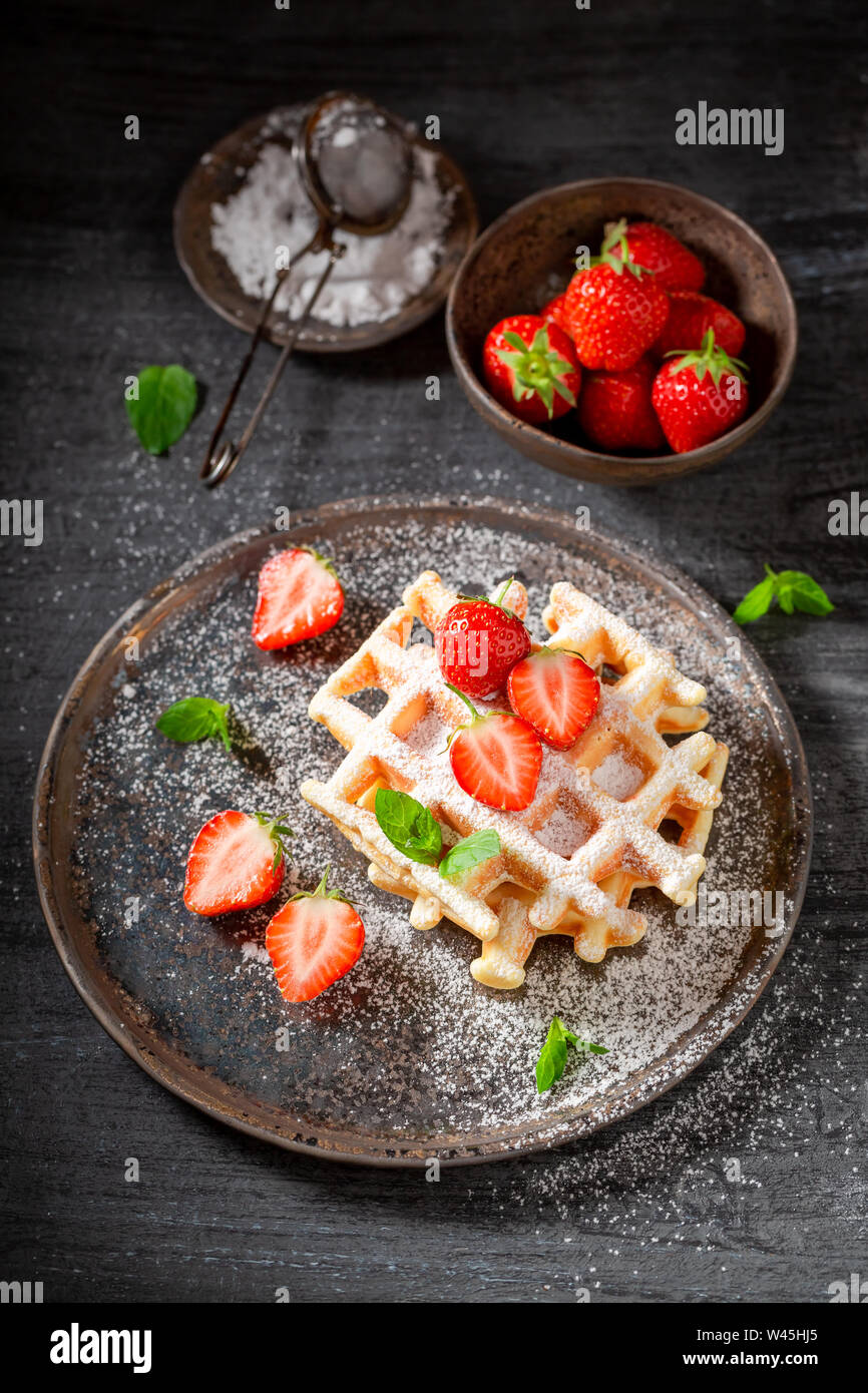 Fresh wafers with powdered sugar and sweet fruits Stock Photo - Alamy