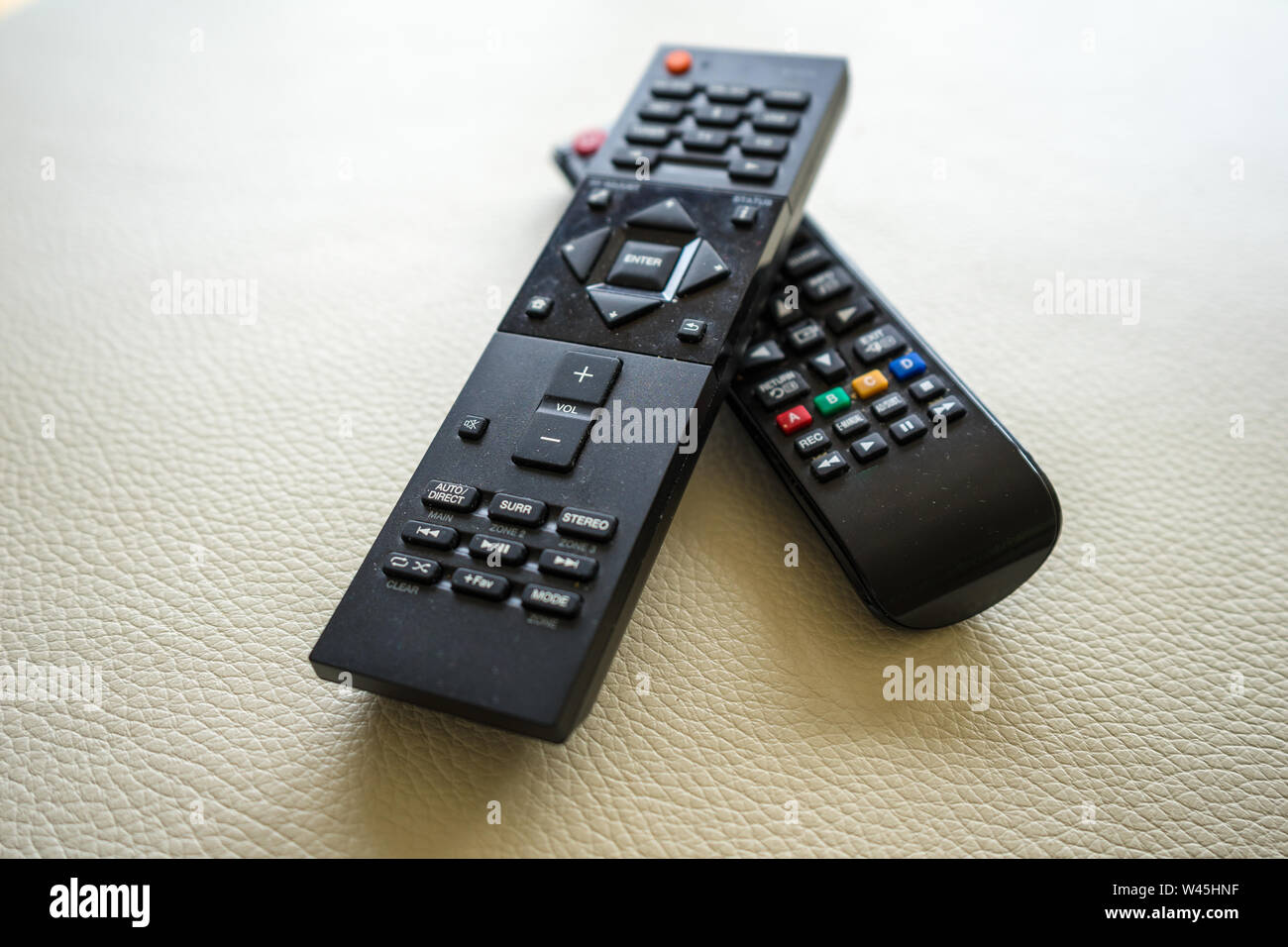 Two tv remote controls on white background Stock Photo - Alamy