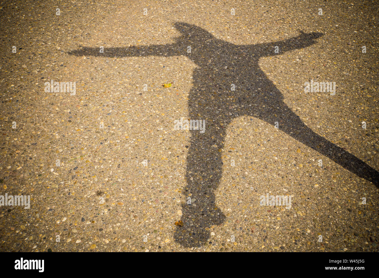 Shadow of a woman jumping in the air on asphalt street in the sun Stock ...