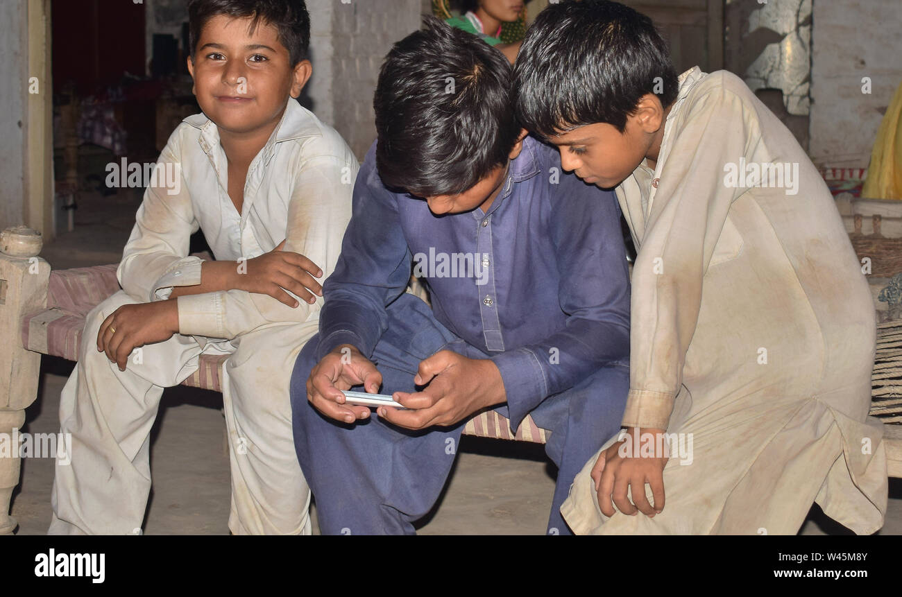 Punjab,Pakistan-August 19,2019:three smart phone addicted boys playing ...