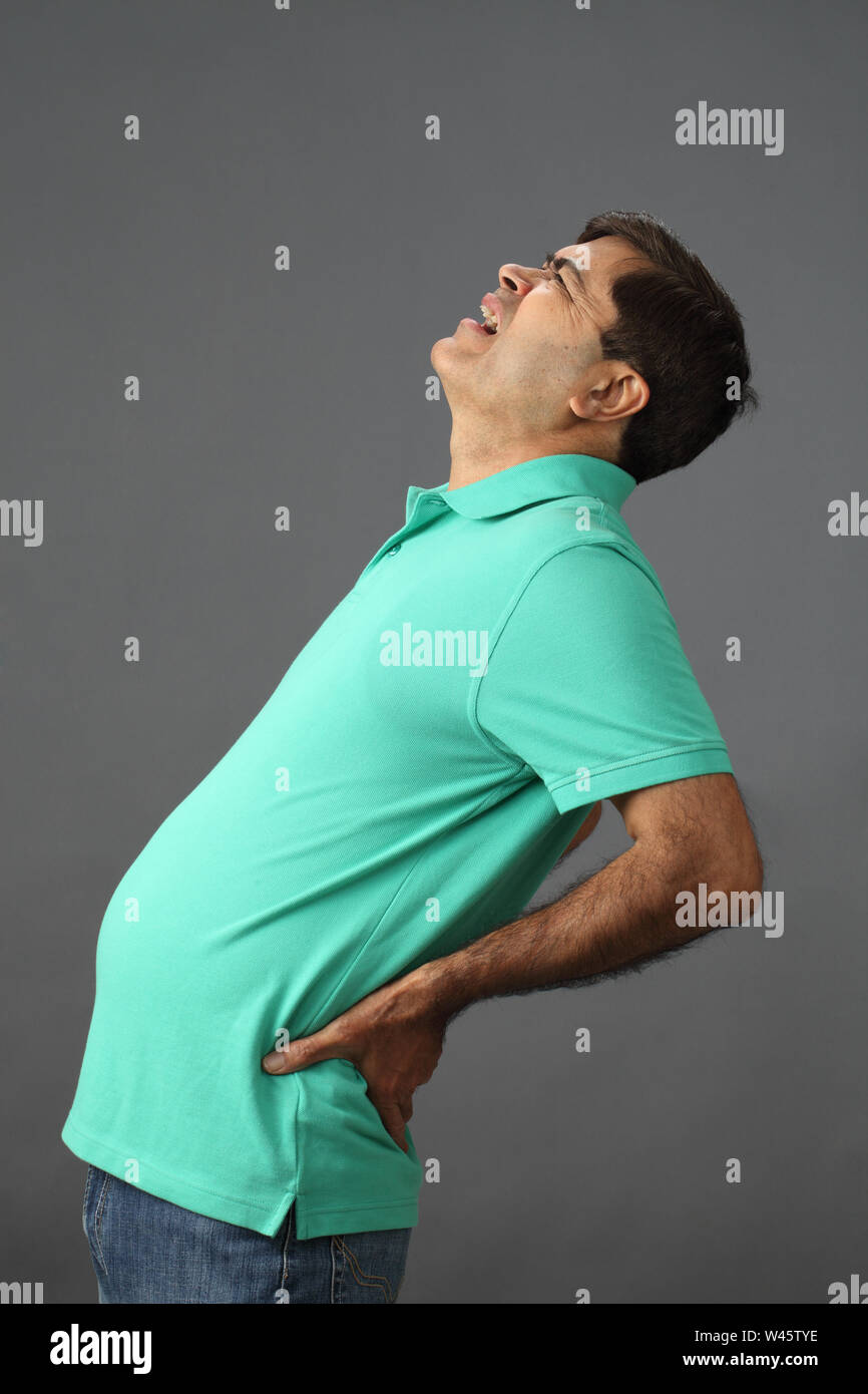 Man suffering from lower back pain Stock Photo - Alamy