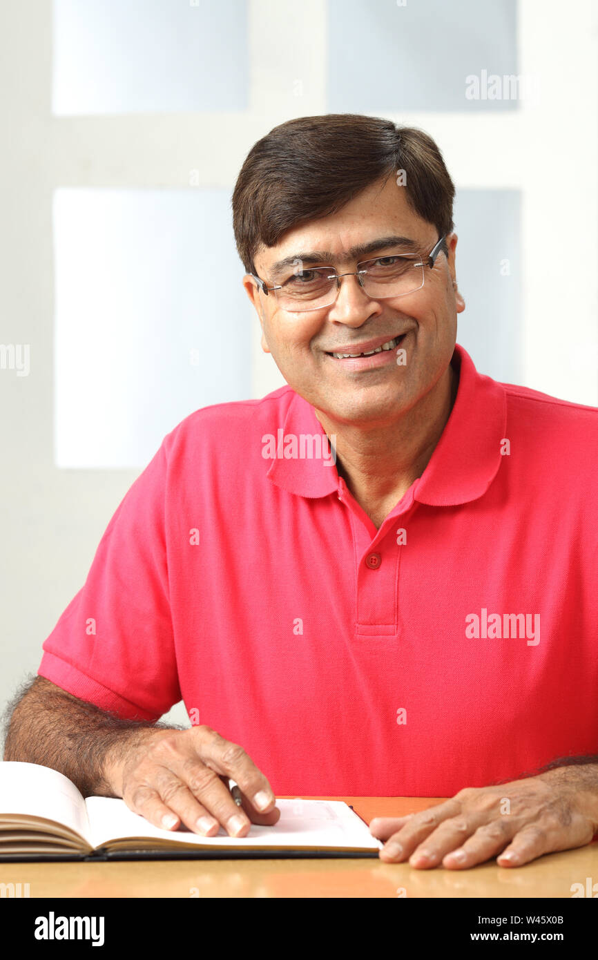 Man writing in a diary Stock Photo - Alamy