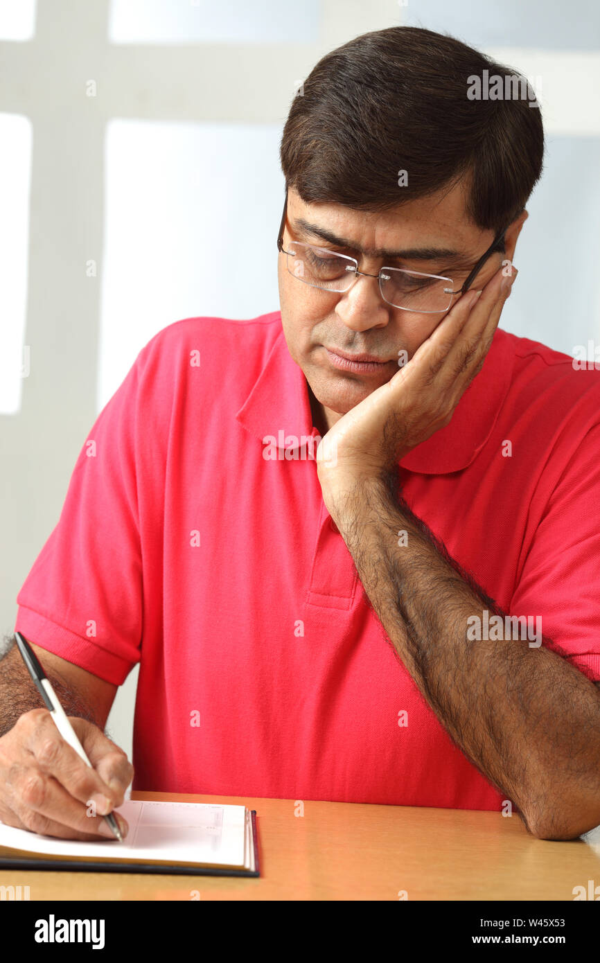Man writing in a diary Stock Photo - Alamy