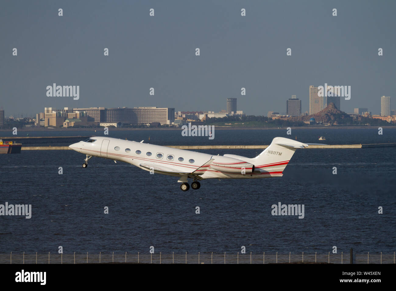 A Gulfstream G650ER executive jet takes off, in front of Tokyo Disney ...