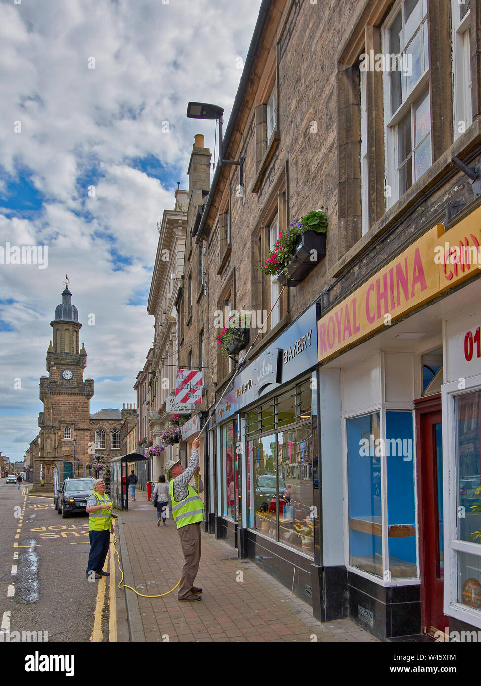 FORRES MORAY SCOTLAND WATERING FLOWERS IN THE HIGH STREET HANGING ...