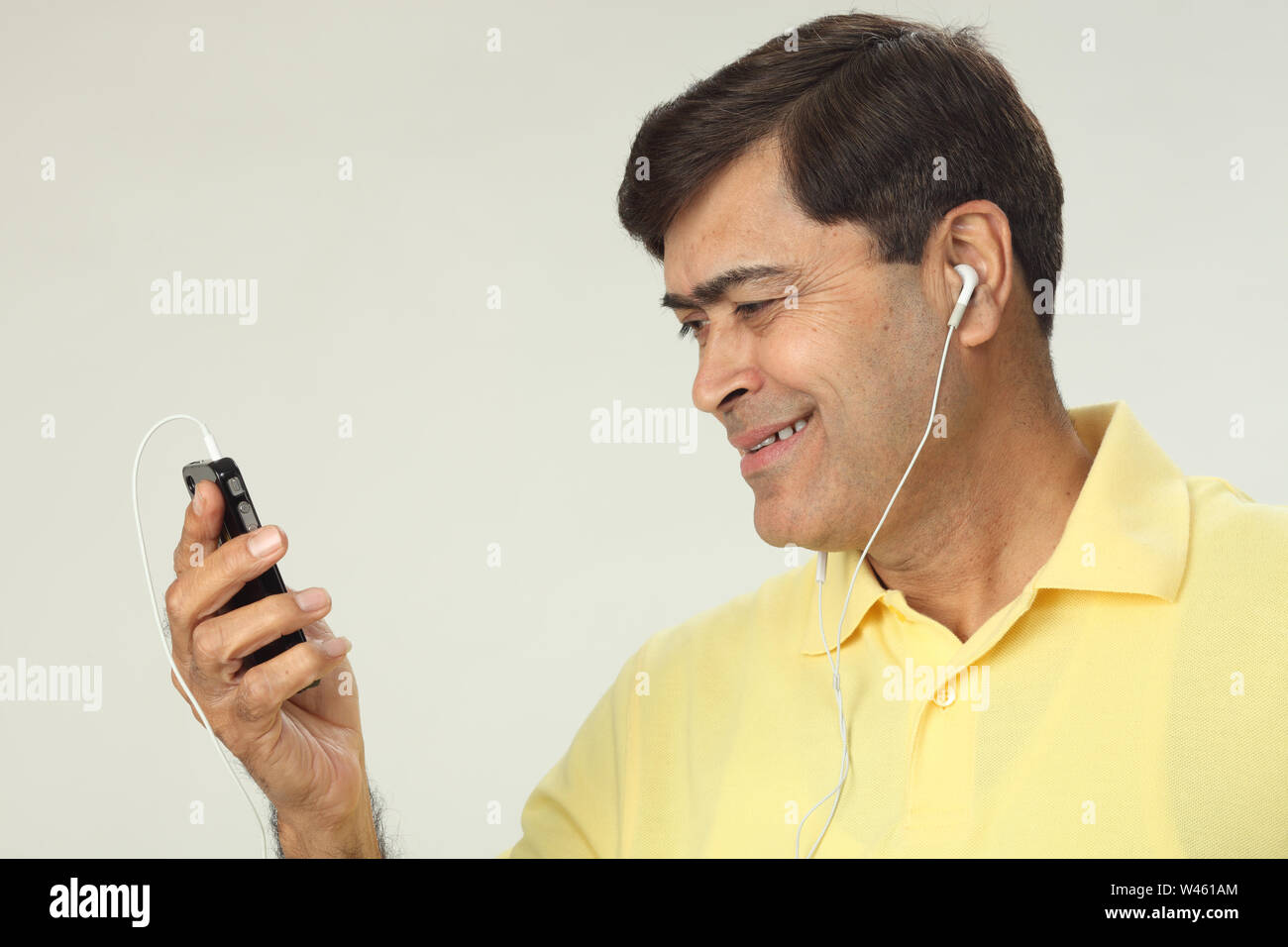 Man listening to music on a mobile phone Stock Photo - Alamy