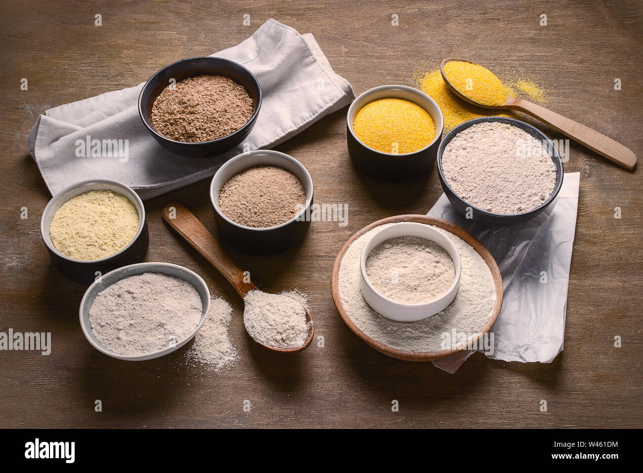 Different types of baking flour on wooden table Stock Photo - Alamy