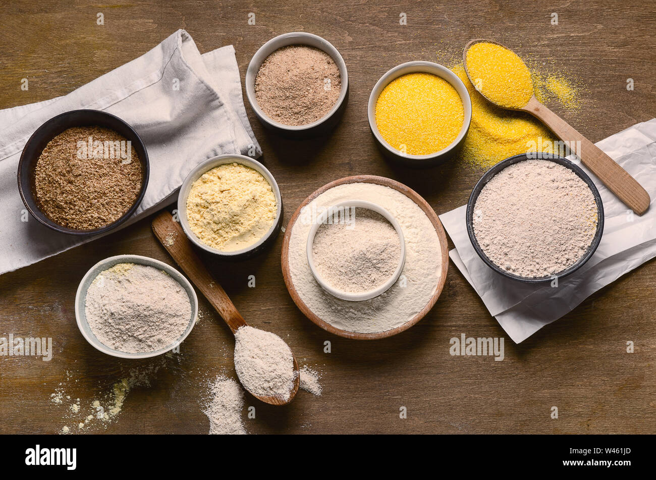 Different types of baking flour on wooden table Stock Photo - Alamy