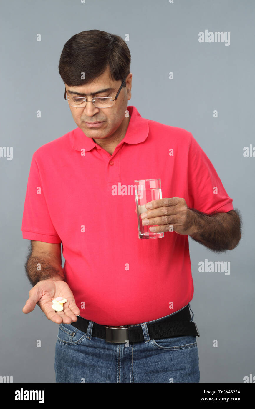 Man taking medicine Stock Photo - Alamy
