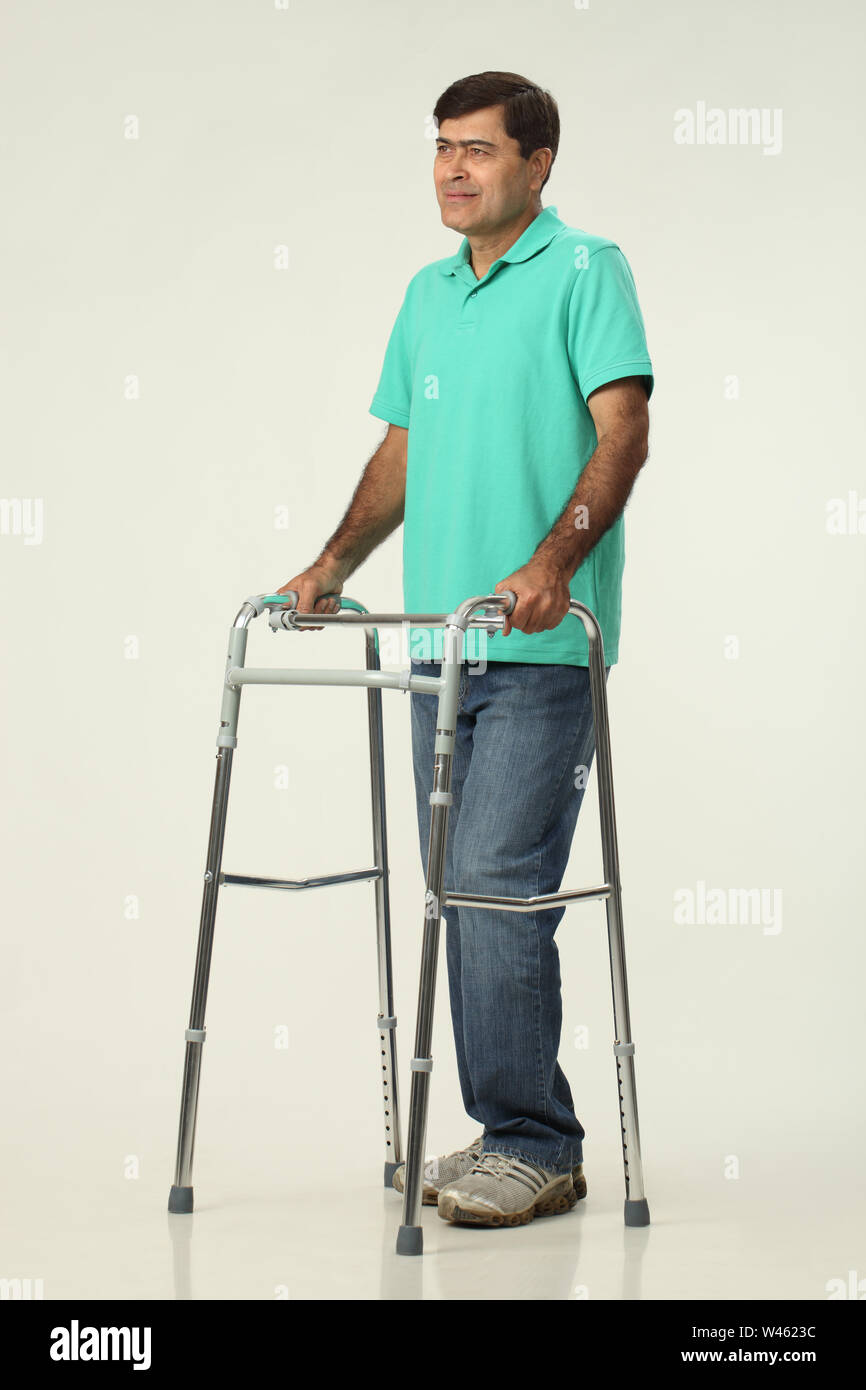 Man standing with a walker Stock Photo - Alamy