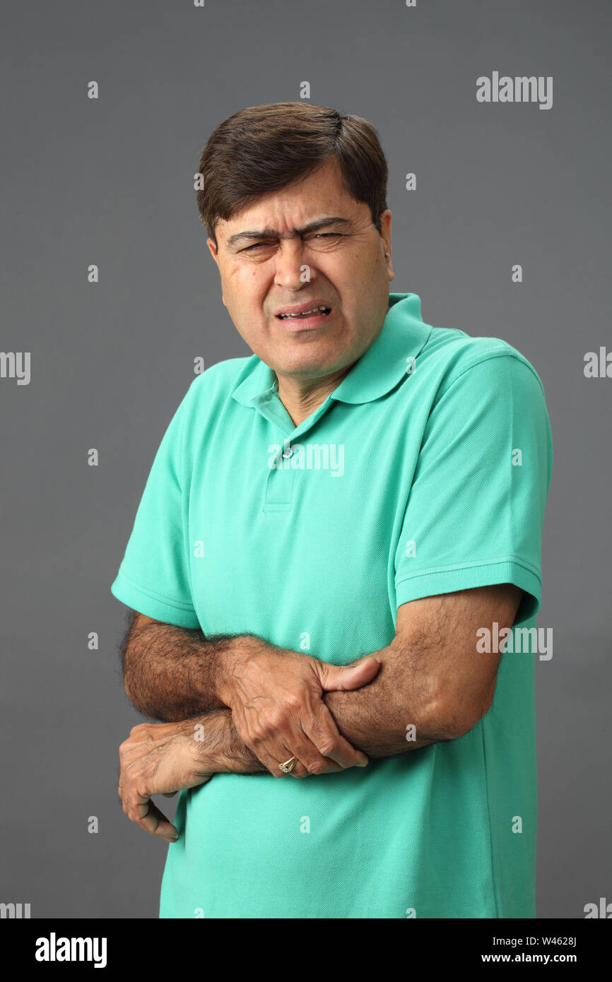 Man suffering from hand pain Stock Photo - Alamy