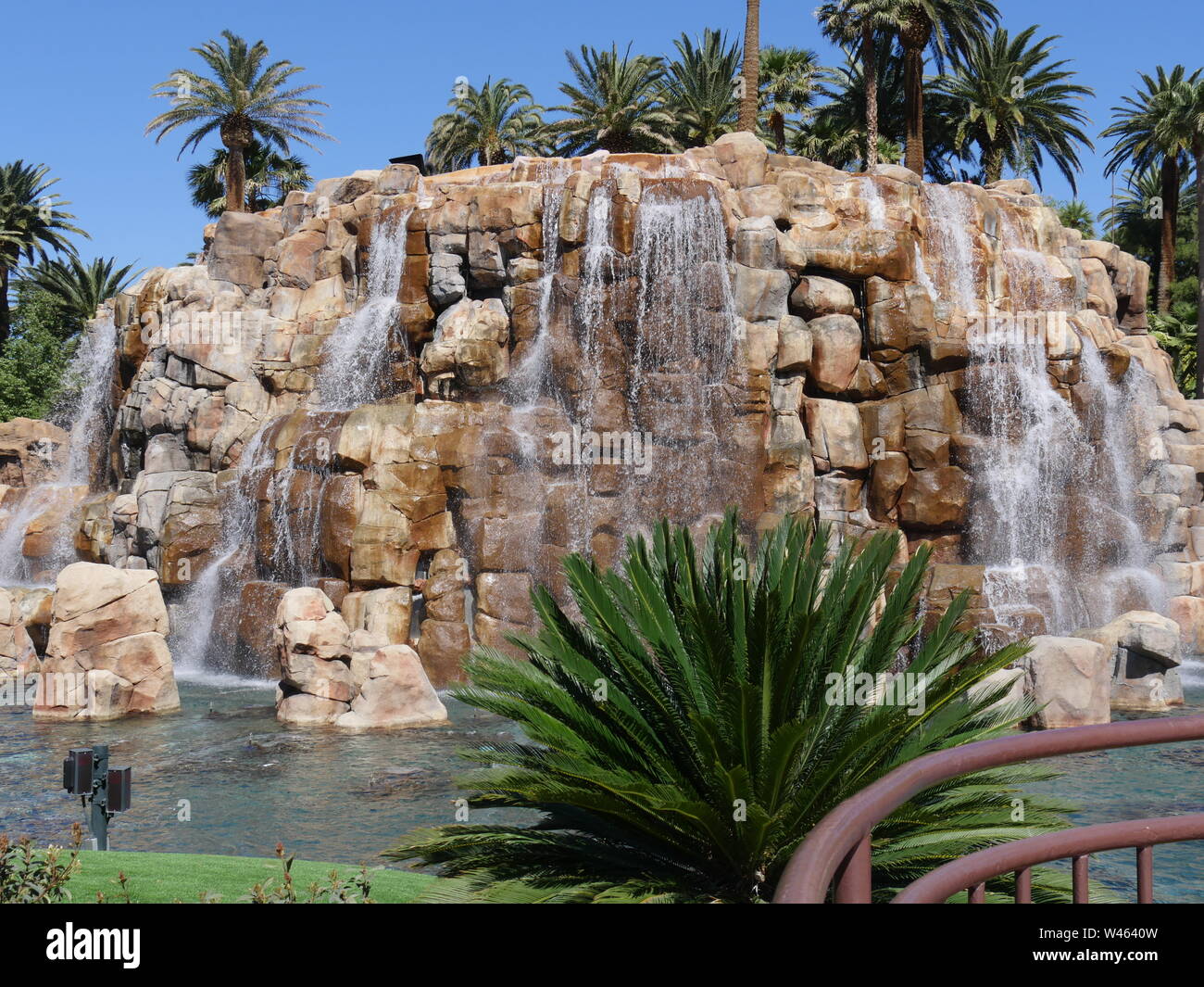Waterfalls in a beautifully-landscaped garden with palm trees Stock ...