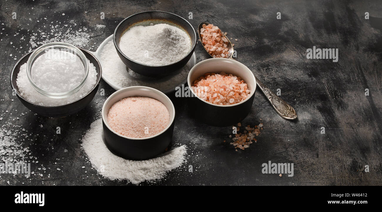 Different types of salt on black background. Image with copy space ...