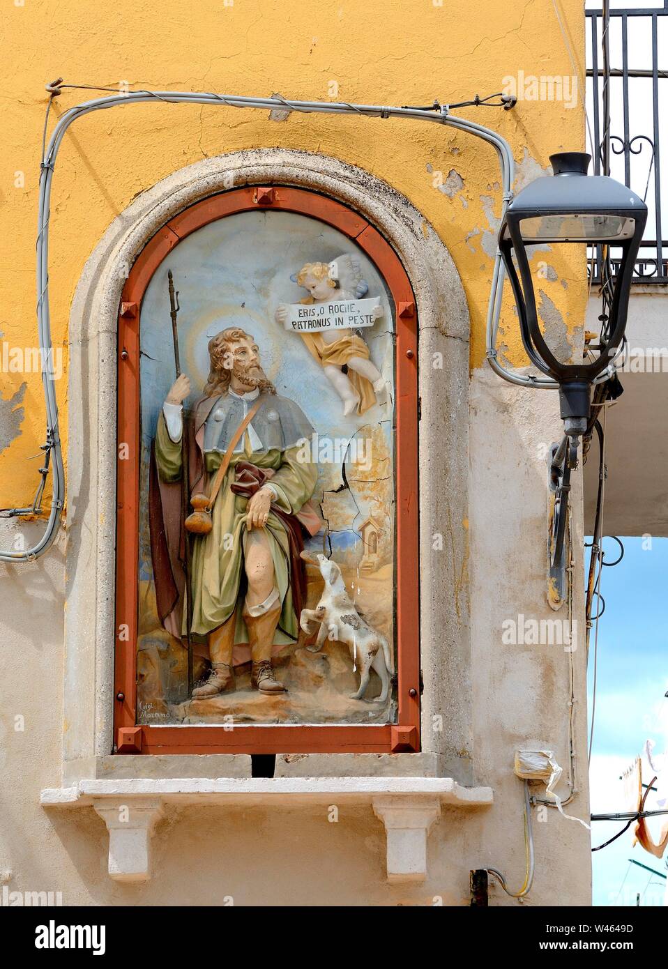 Painting of patron saint on a wall with power cables hi-res stock ...