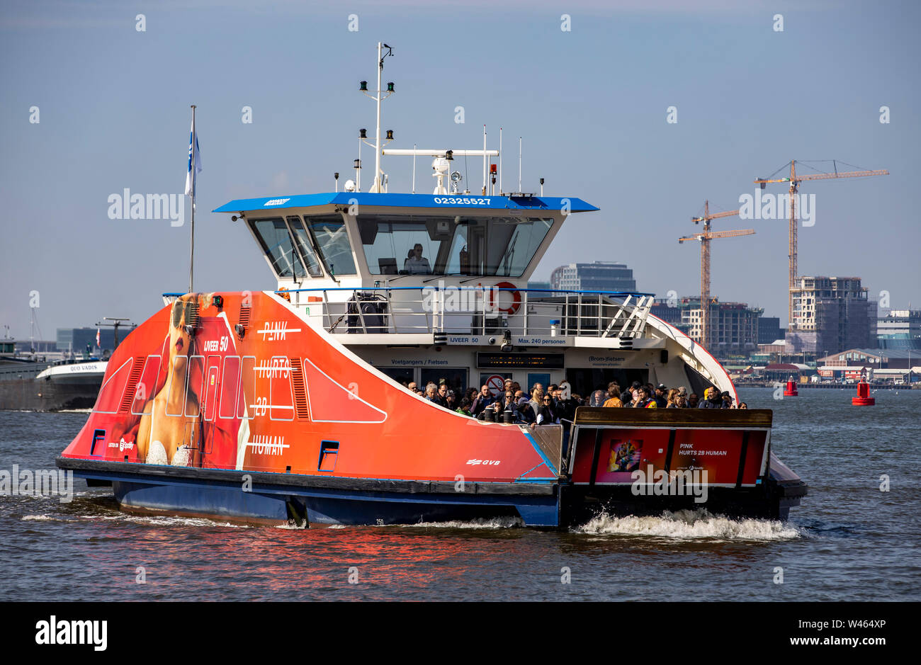 Amsterdam, Netherlands, passenger and bicycle ferry across the river Ij ...
