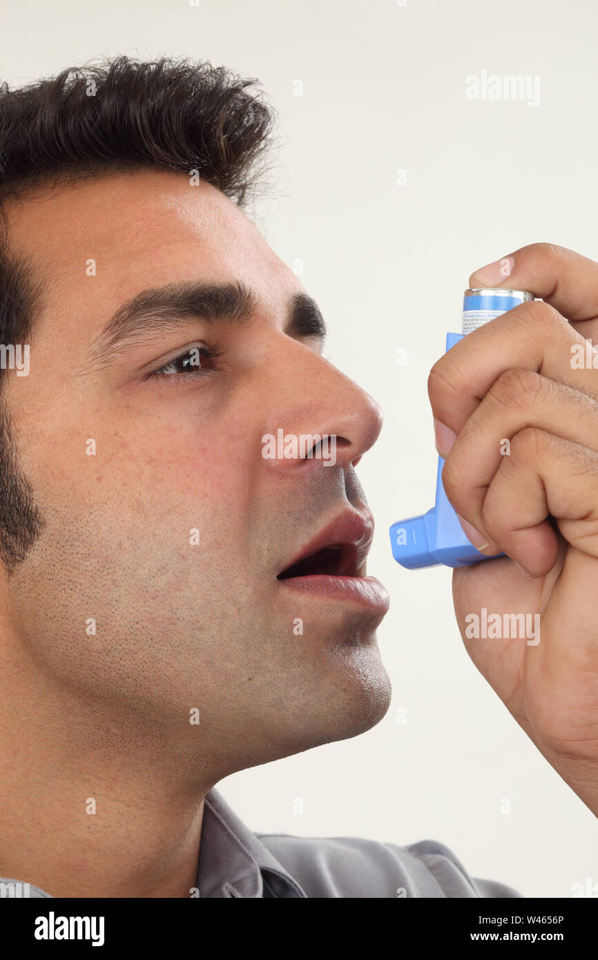 Man using asthma inhaler Stock Photo - Alamy