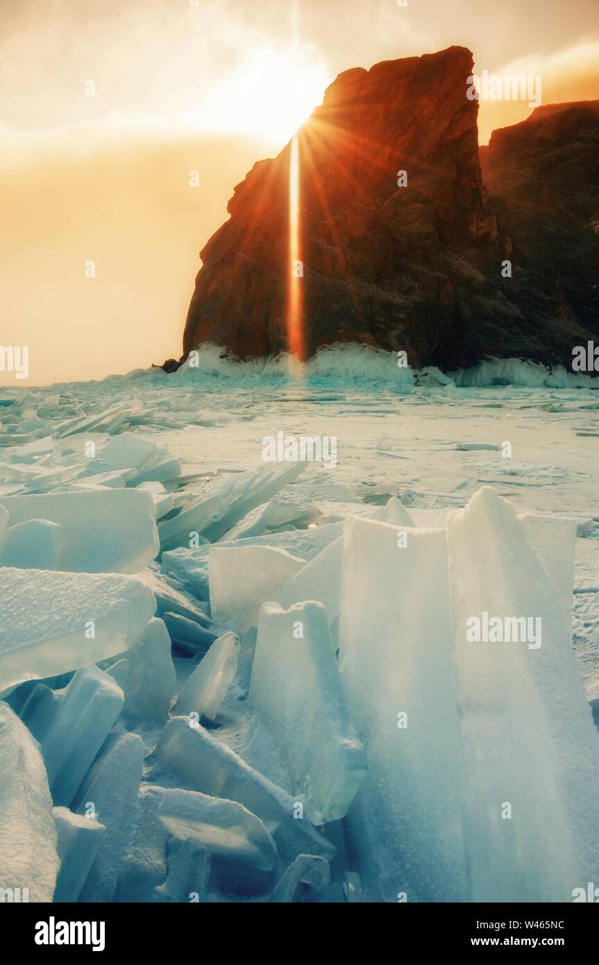 Field of blue ice and rocks with sun Stock Photo - Alamy
