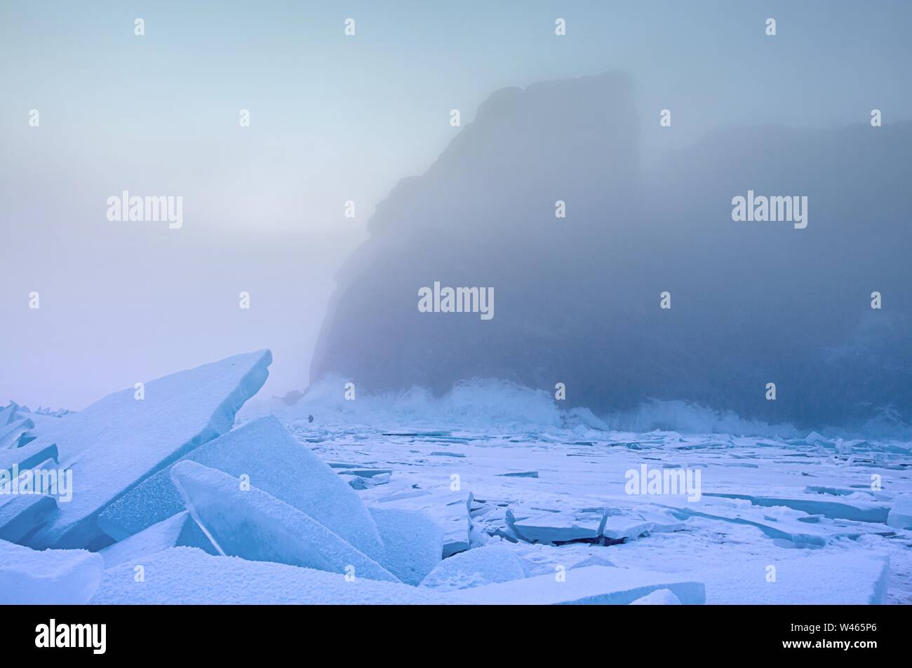 Field of blue ice and rocks in the fog Stock Photo - Alamy