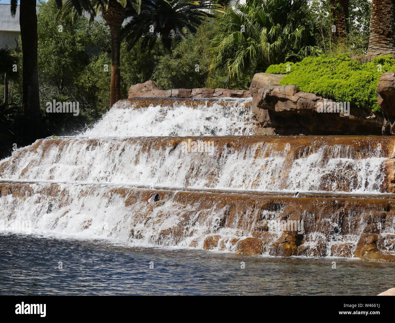 View of water cascading down a waterfalls in a garden Stock Photo - Alamy