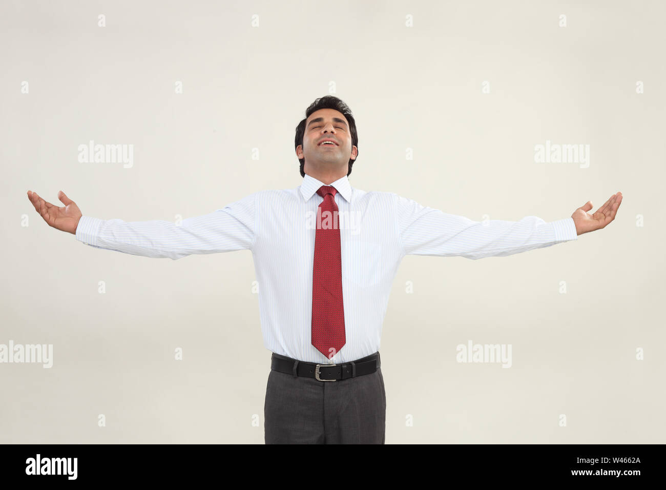 Businessman standing with his arm outstretched Stock Photo - Alamy