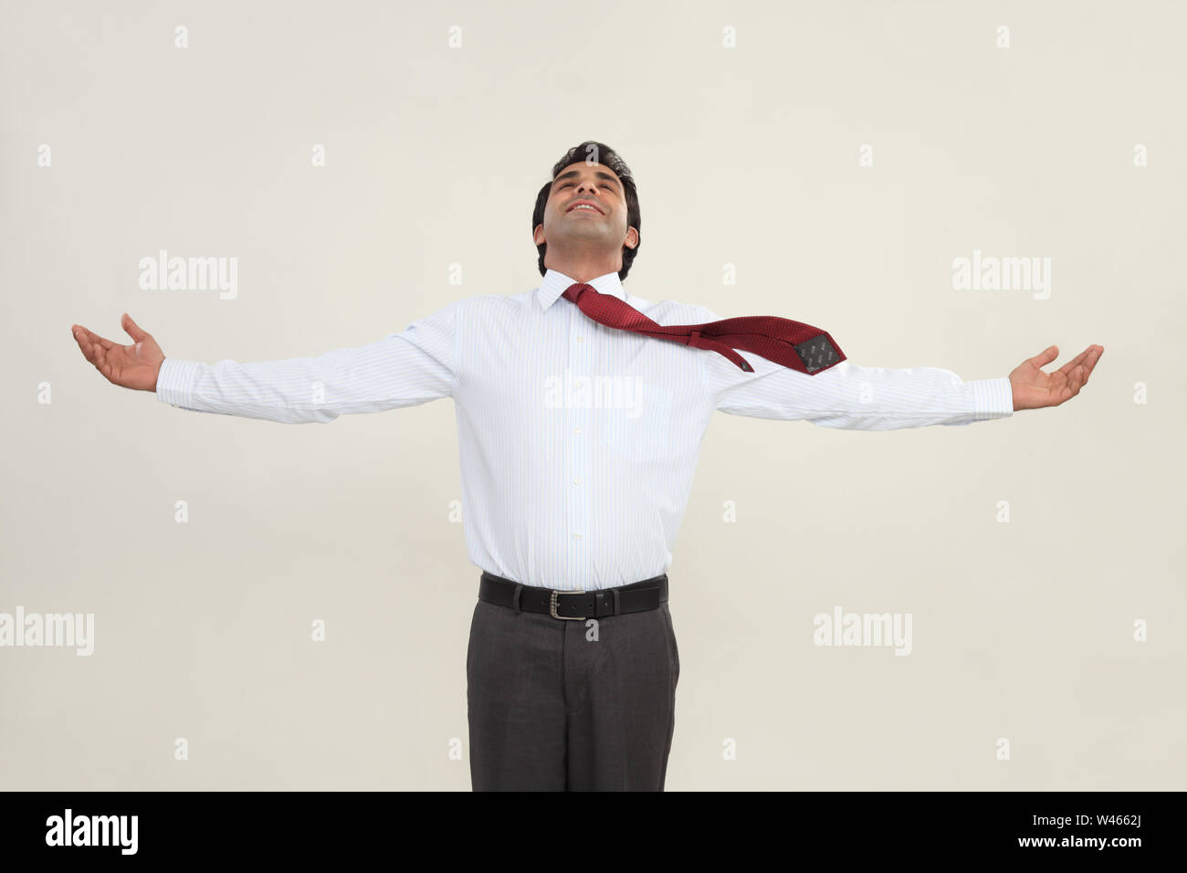 Businessman standing with his arm outstretched Stock Photo - Alamy