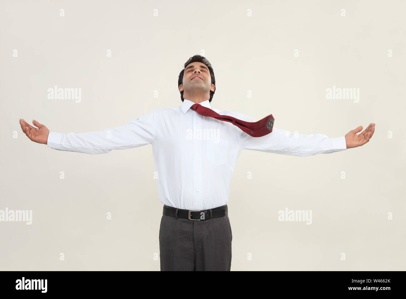 Businessman standing with his arm outstretched Stock Photo - Alamy