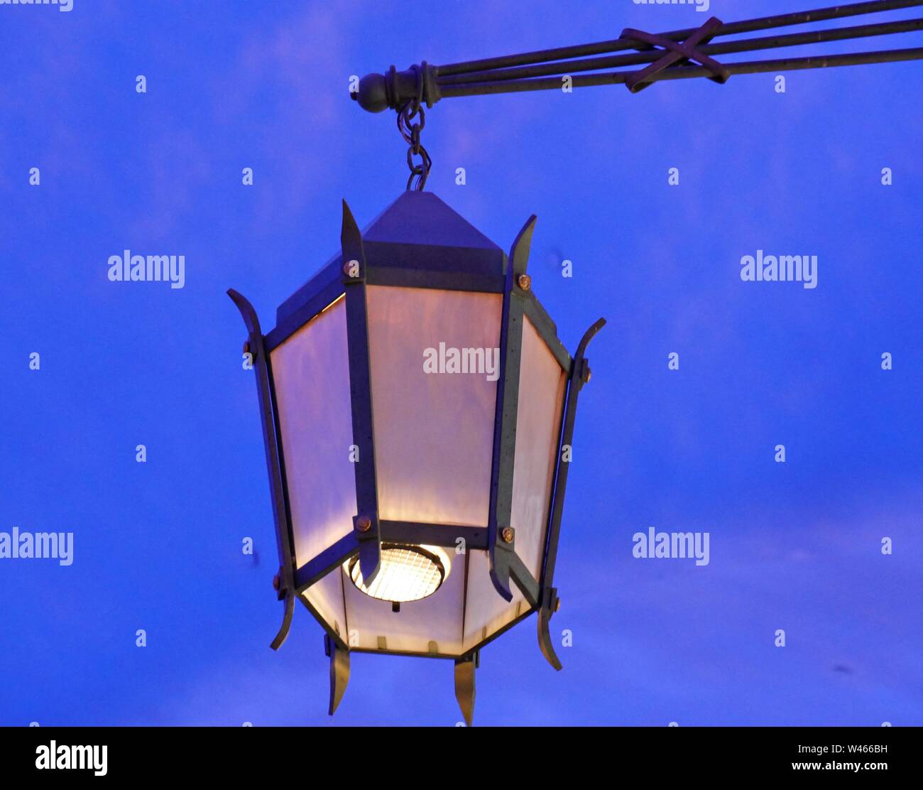 Close up shot of a lighted lamp post, with blue background Stock Photo ...