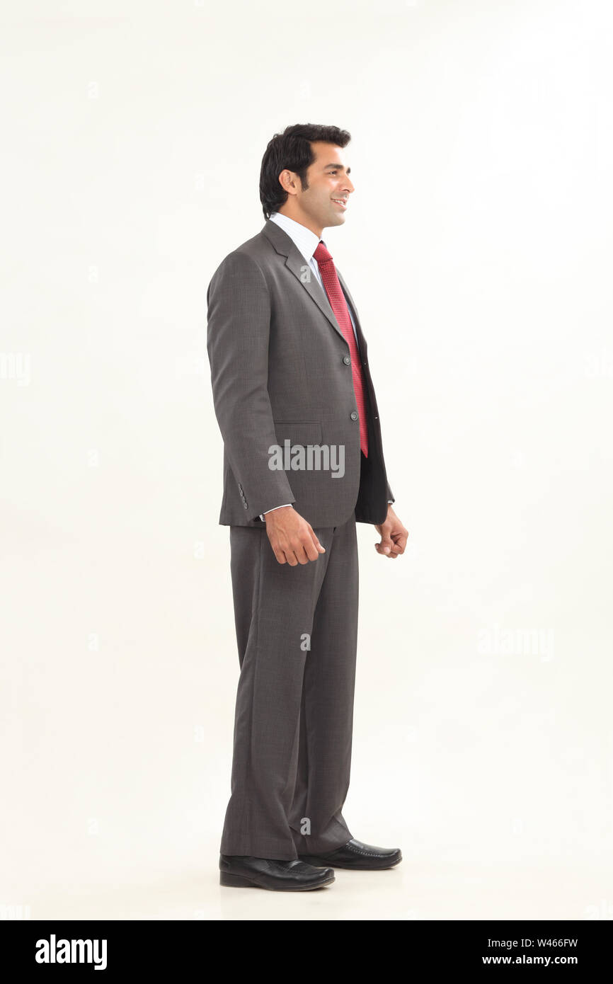 SIde profile of a businessman standing Stock Photo - Alamy