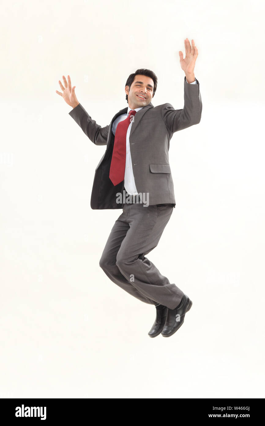 Businessman jumping in air Stock Photo - Alamy