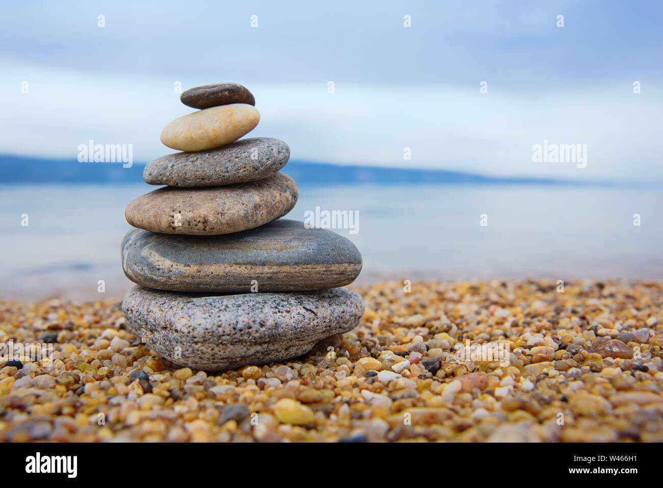 pyramid of colorful pebbles . Rock Zen in the background of the sea ...