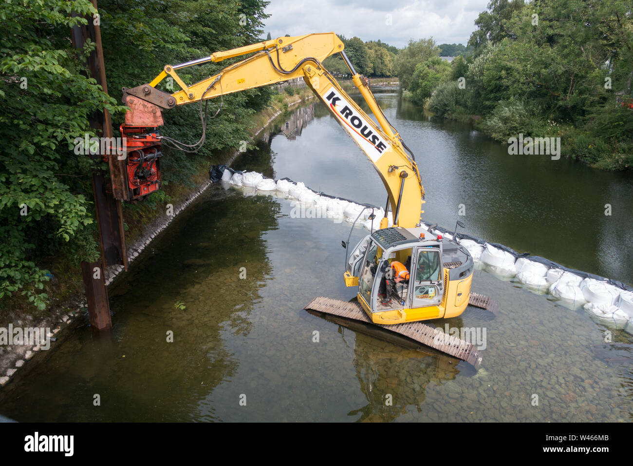 A temporary dam being installed on the River Kent in Kendal, Cumbria ...
