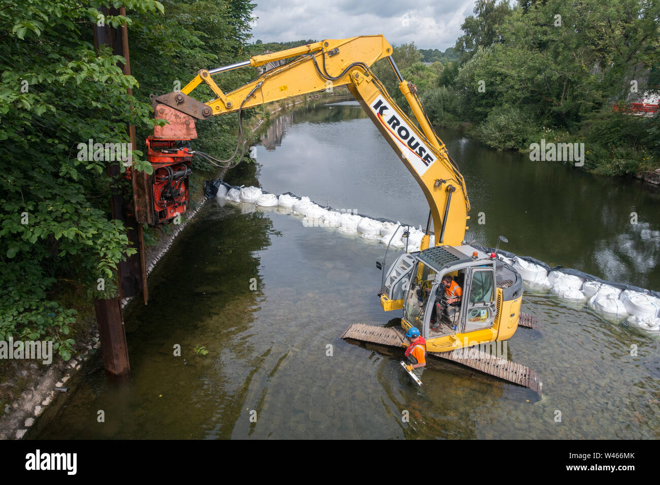 A temporary dam being installed on the River Kent in Kendal, Cumbria ...