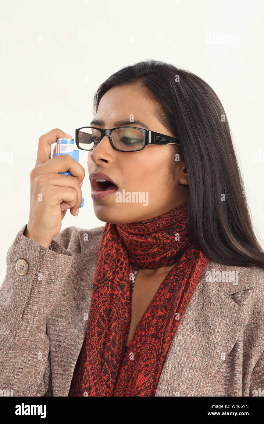 Woman using asthma inhaler Stock Photo - Alamy