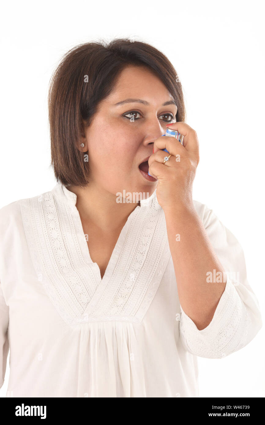 Woman using asthma inhaler Stock Photo - Alamy