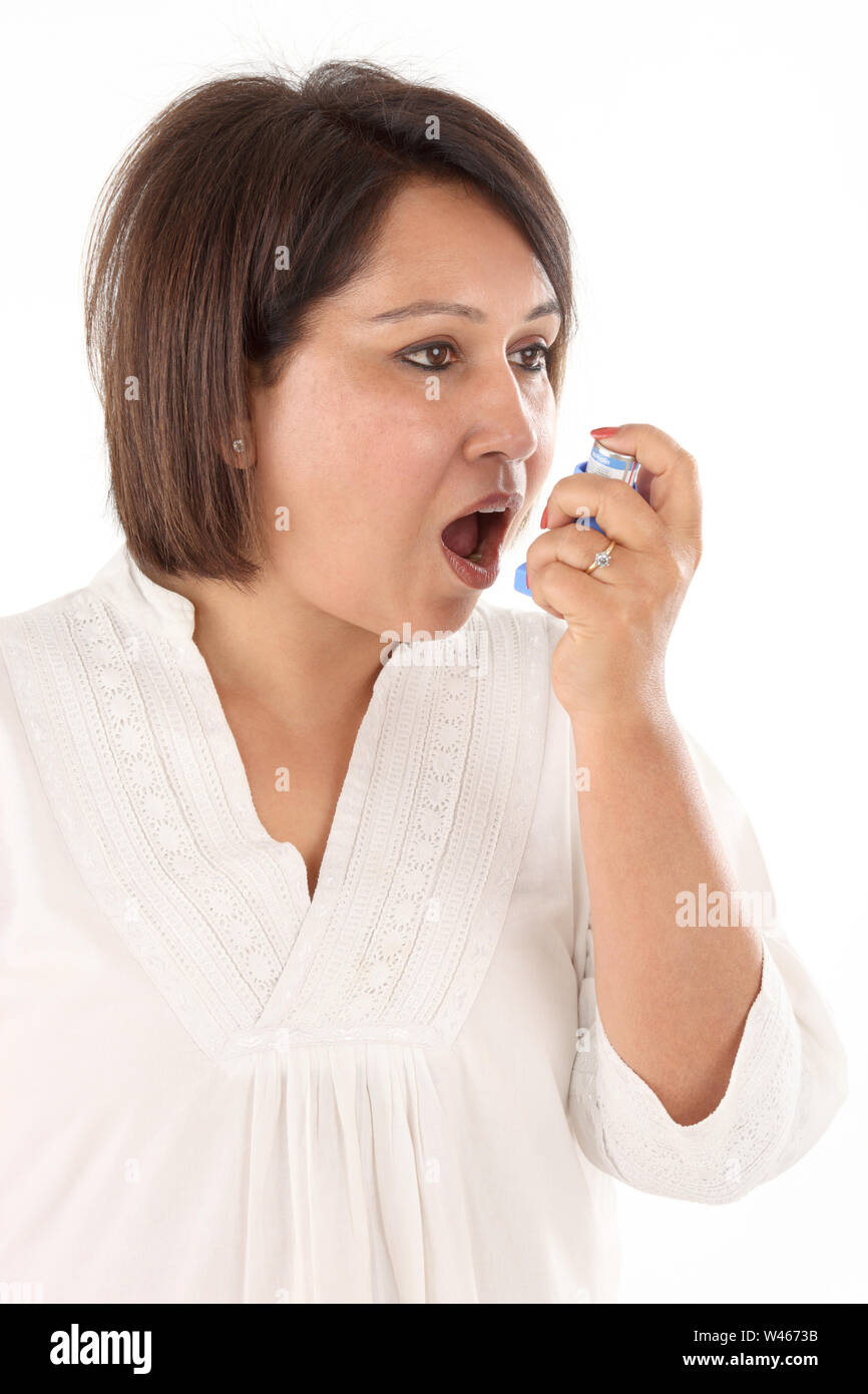 Woman using asthma inhaler Stock Photo - Alamy
