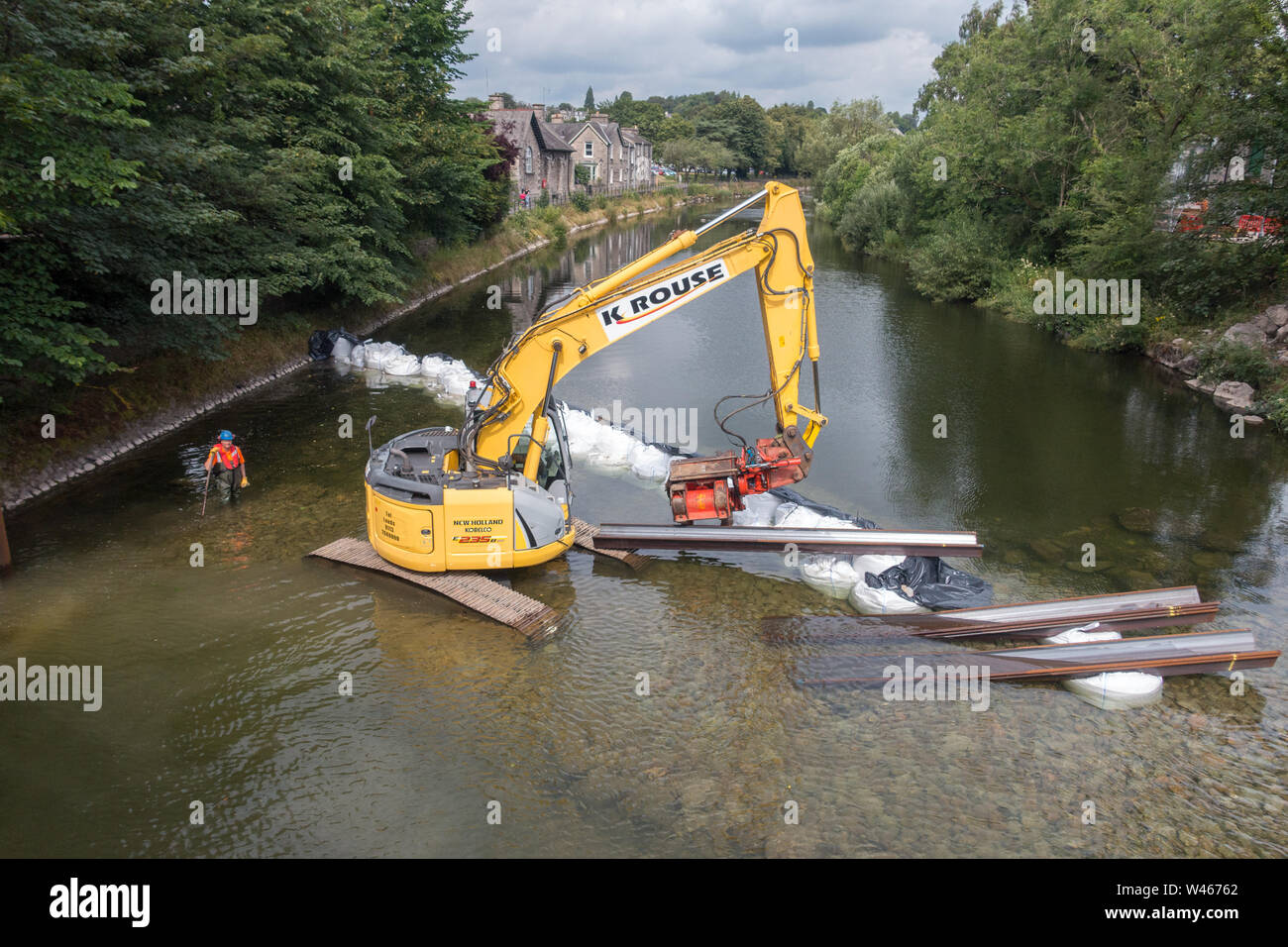 A temporary dam being installed on the River Kent in Kendal, Cumbria ...