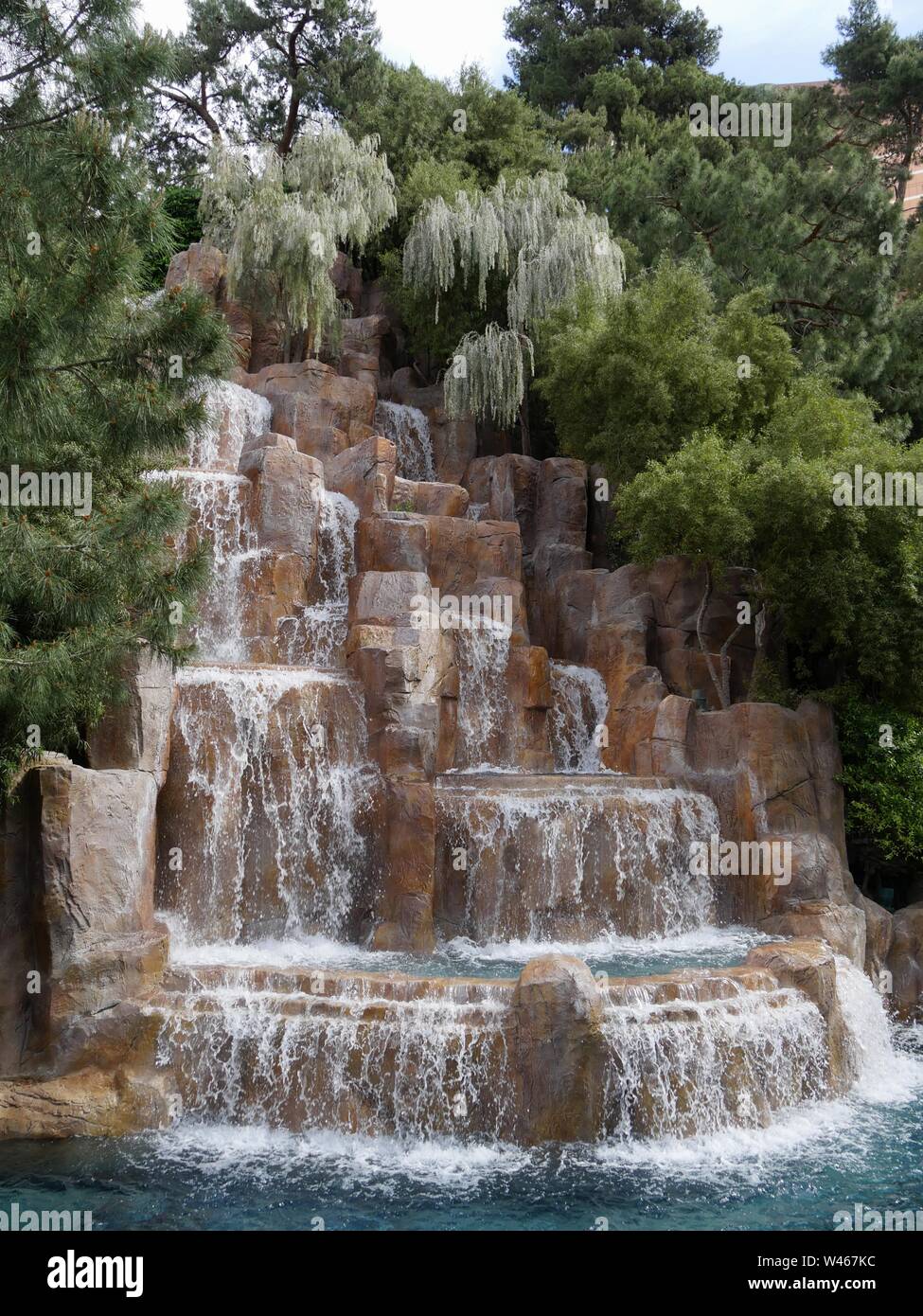 Full view of a man-made waterfalls in a landscaped garden Stock Photo ...