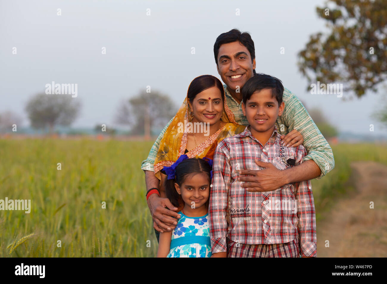 Rural family standing in a field Stock Photo - Alamy