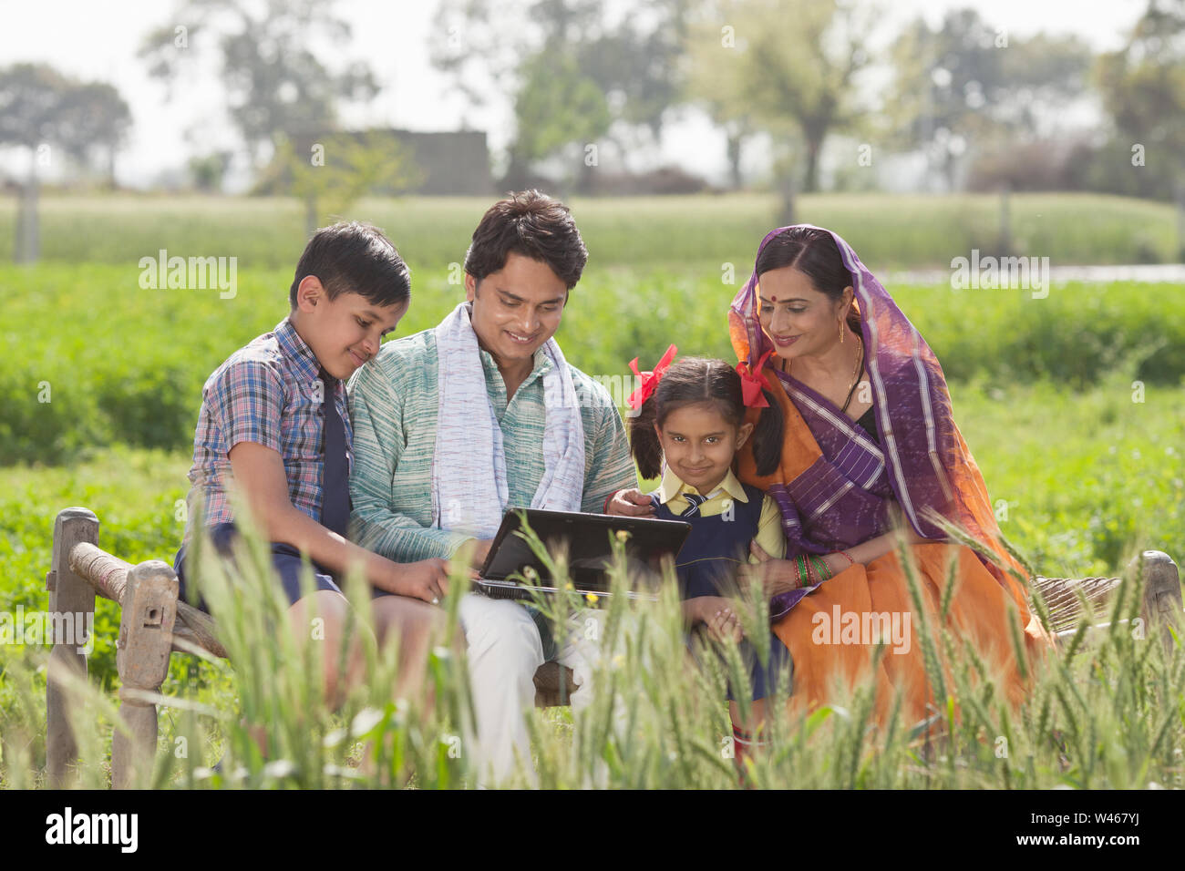 Rural family using laptop Stock Photo - Alamy