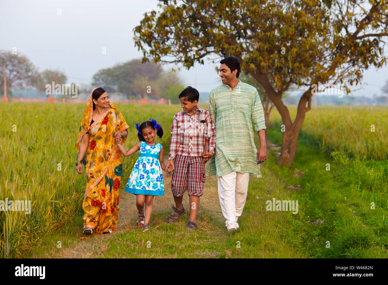 Rural family walking in a field Stock Photo - Alamy